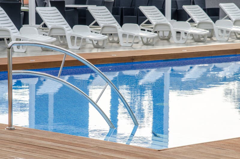 Clean Swimming Pool and Empty Resting Chair Stock Image - Image of ...