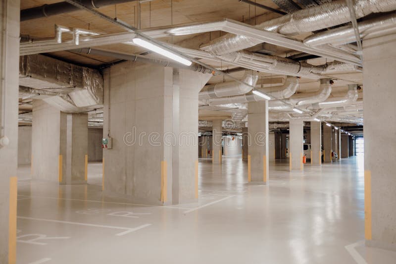 Clean, Well-lit Underground Parking Garage with Concrete Pillars Stock ...