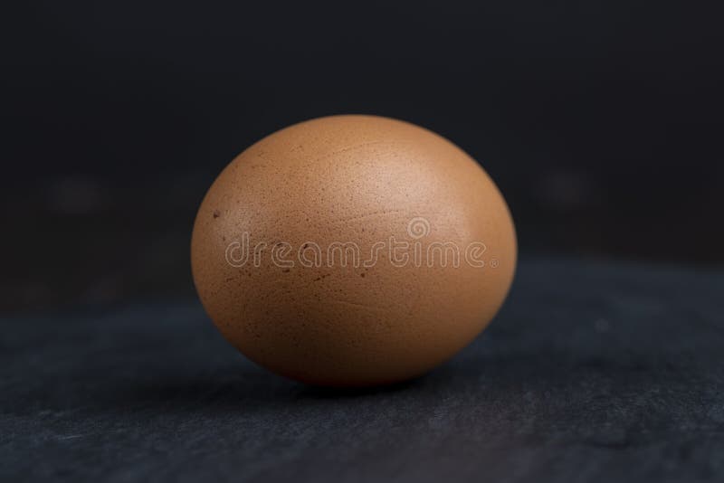 A Clean Whole Orange Chicken Egg Close-up on the Table Stock Image ...