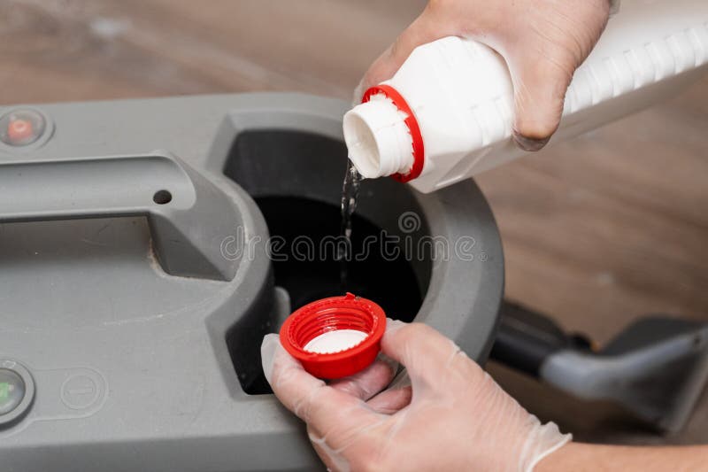 Cleaner Pours Chemicals into the Extractor Machine for Dry Cleaning by ...