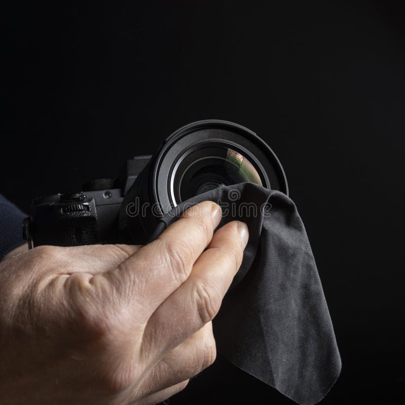 Cleaning a camera lens stock photo. Image of camera - 219917906