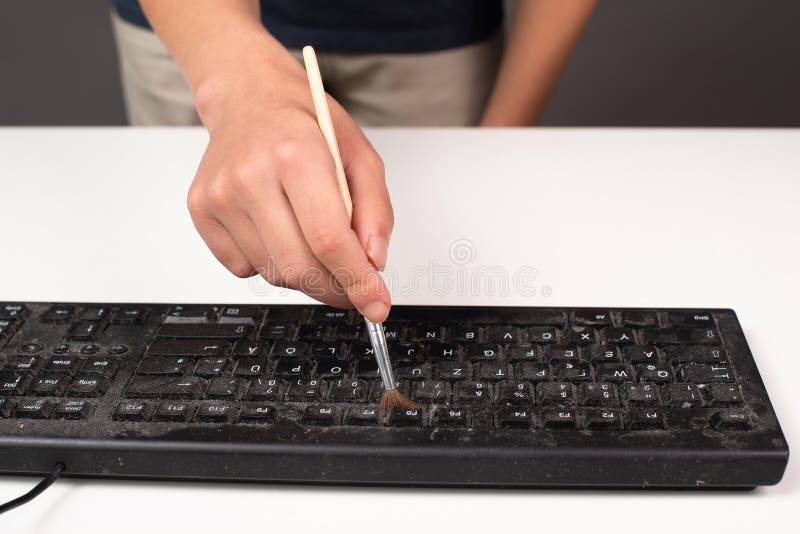 Cleaning Computer Keyboard in Office with Rubber Protective Glove and a ...