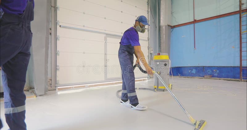 Cleaning the Construction Site from Dust. a Builder Cleans the ...