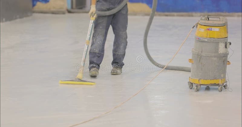 Cleaning the Construction Site from Dust. a Builder Cleans the ...
