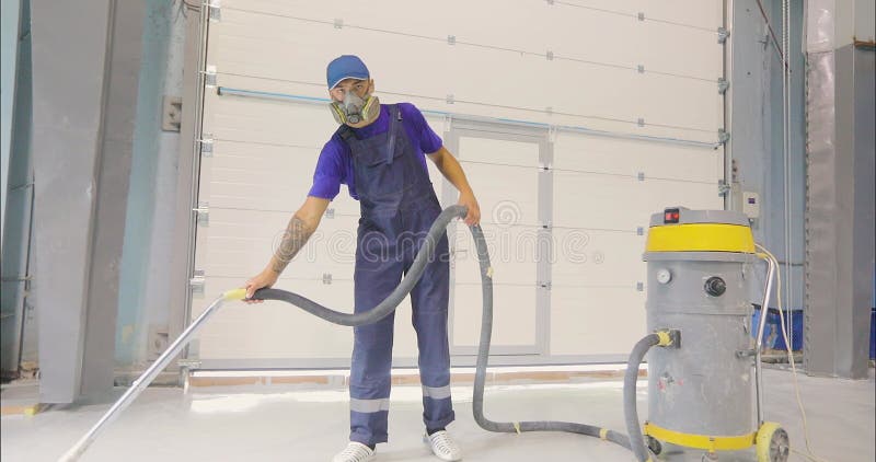 Cleaning the Construction Site from Dust. a Builder Cleans the ...