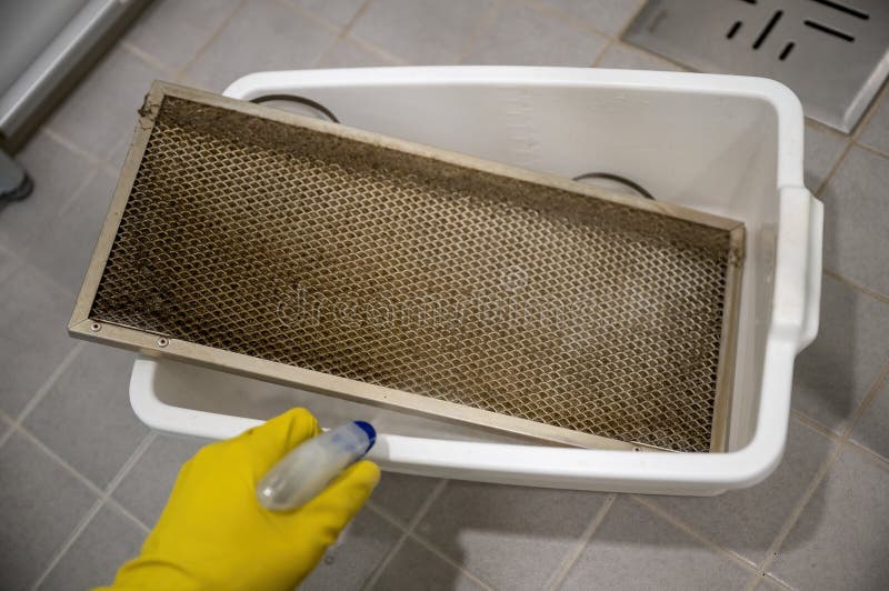 Cleaning Dirty Kitchen Range Hood Grease Filter with Spray Bottle and ...