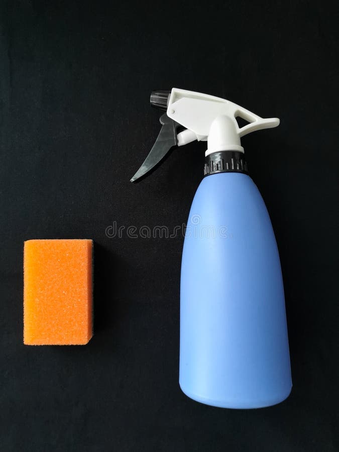 Cleaning and Disinfecting. Orange Sponge and Blue Sprayer on a Black ...