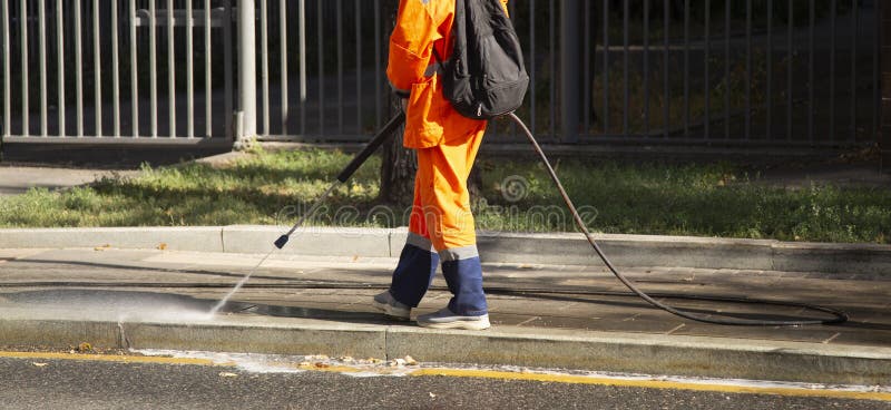 Cleaning of Footpaths by a Utility Worker Using Water and Shampoo Stock ...