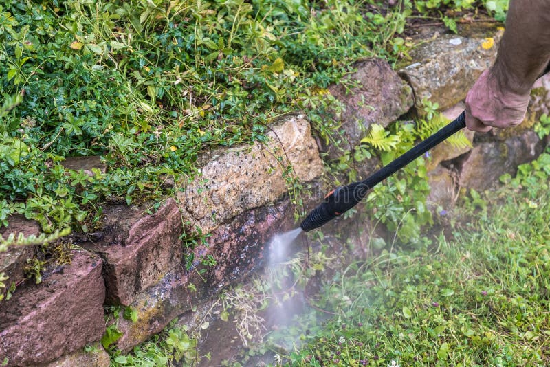 Cleaning of a Sandstone Wall with a High-pressure Cleaner Stock Photo ...