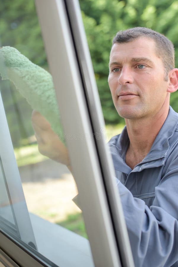 Cleaning a glass window stock photo. Image of employment - 122052618