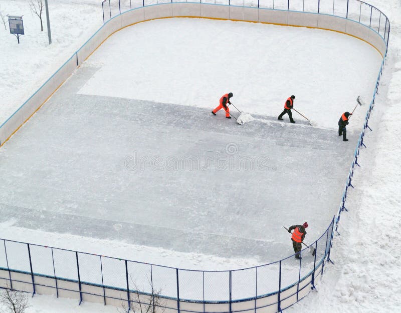 Cleaning of the Ice Rink from the Snow in the Yard of the House ...