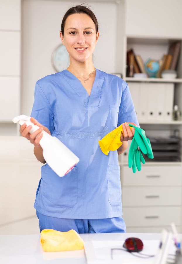 Cleaning Lady of Cleaning Company Wipes Dust from Table in Office Stock ...