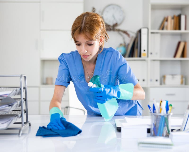 Cleaning Lady of Cleaning Company Wipes Dust from Table in Office Stock ...