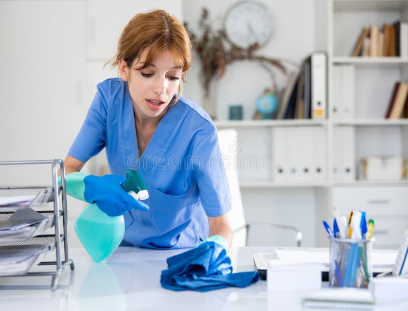 Cleaning Lady of Cleaning Company Wipes Dust from Table in Office Stock ...