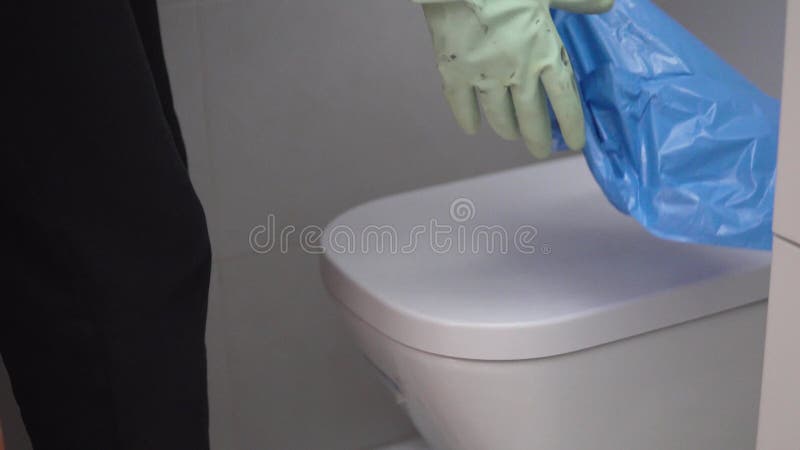 The Cleaning Lady Puts on Rubber Gloves and Opens a Garbage Plastic Bag ...