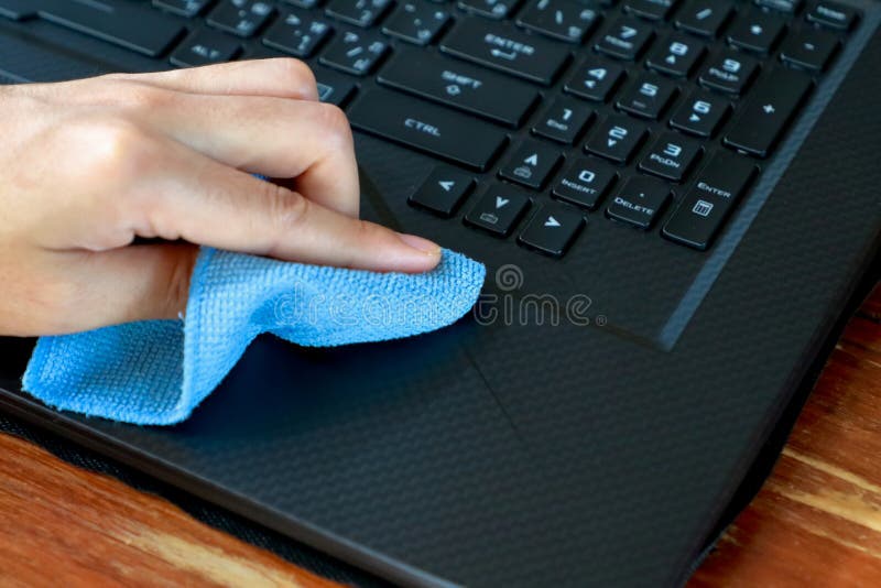 Cleaning the Laptop Computer with Microfiber Cloth by Hand Stock Photo ...