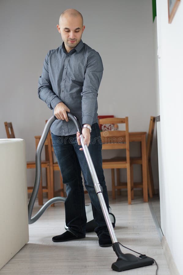 Black Man Cleaning House with Wireless Vacuum Cleaner Stock Photo ...