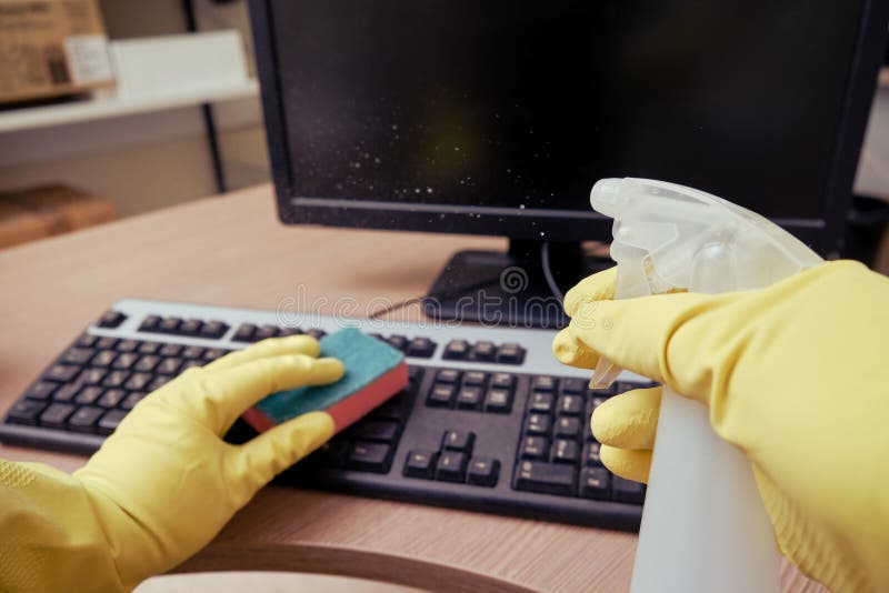 Cleaning the Office, a Janitor in Yellow Gloves Wipes Keyboard and ...