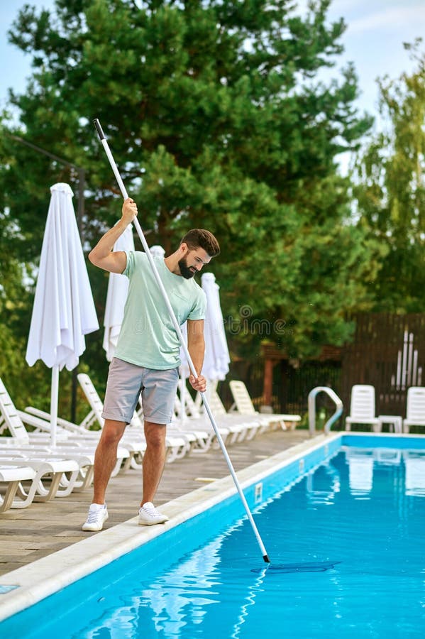 A Service Person Cleaning the Swimming Pool and Looking Busy Stock ...