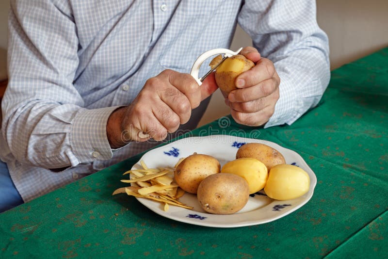 Cleaning Potatoes. Woman`s Hands Clean Potatoes Special Tool Stock ...