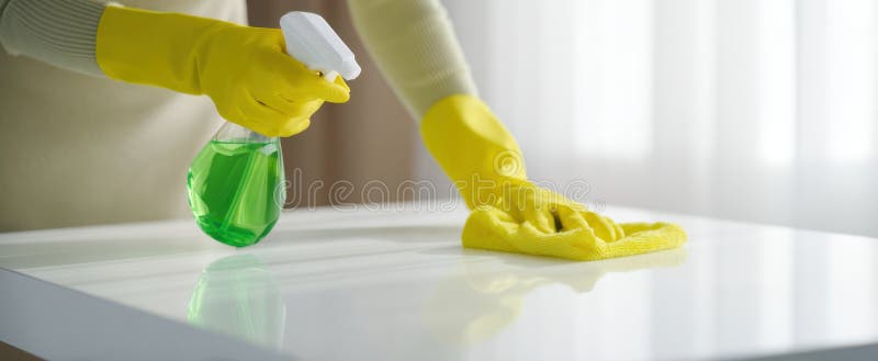 The Cleaning Process with a Spray Bottle and Yellow Cloth on a Shiny ...