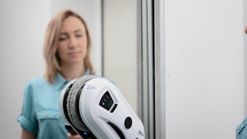 Cleaning Robot at Work at Home. the Robot Cleans the Mirror in the ...