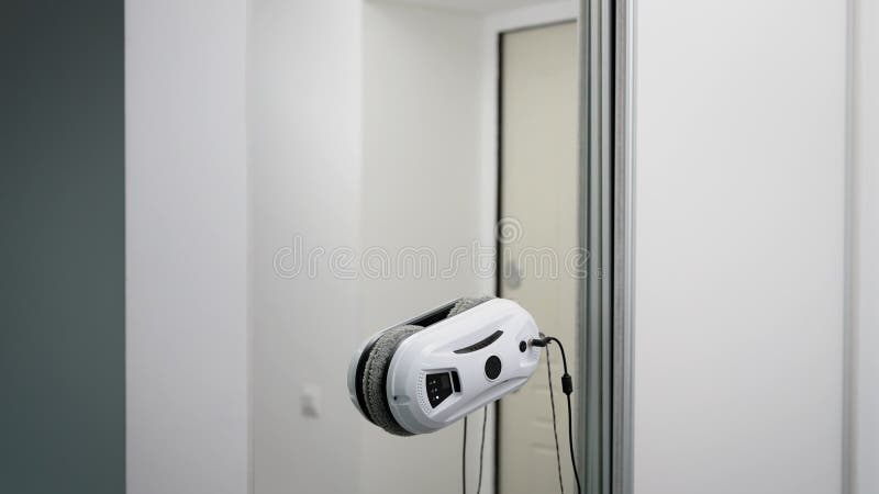 Cleaning Robot at Work at Home. the Robot Cleans the Mirror in the ...
