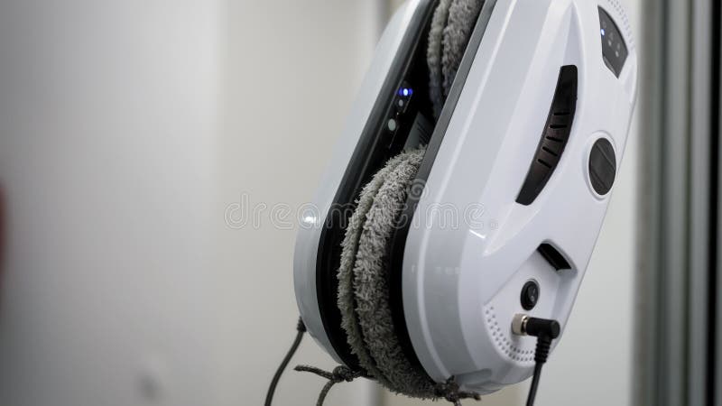 Cleaning Robot at Work at Home. the Robot Cleans the Mirror in the ...