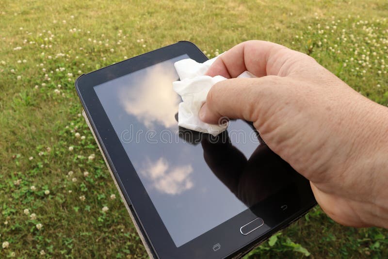 Cleaning the Screen of a Tablet. a Blue Sky with White Clouds Can Be ...