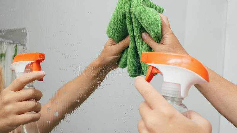 Cleaning and Polish Mirror with Rag and Spray in Bathroom at Home ... Cleaning and Polish Mirror with Rag and Spray in Bathroom at Home ...
