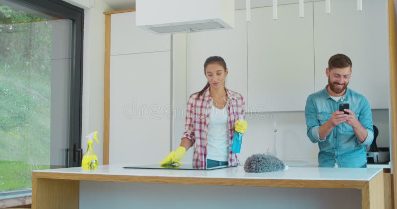 Cleaning Service Team at Work in Kitchen.Man Using Smartphone. Stock ...