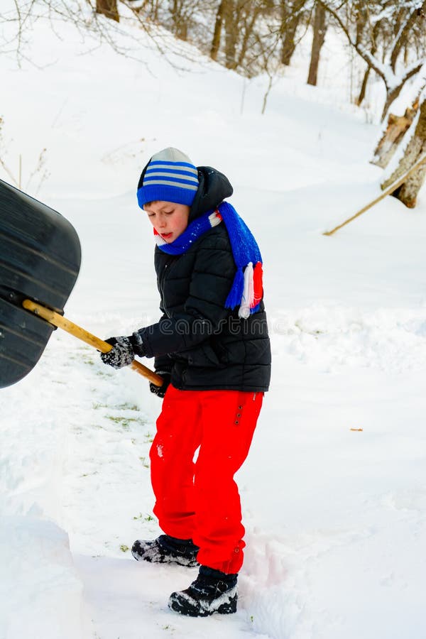 Cleaning Snow in Winter, the Boy Shovels Snow Stock Photo - Image of ...