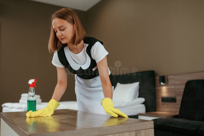 Cleaning the Table. Young Chambermaid is in Hotel Room Stock Photo - Image of bottle, yellow ...