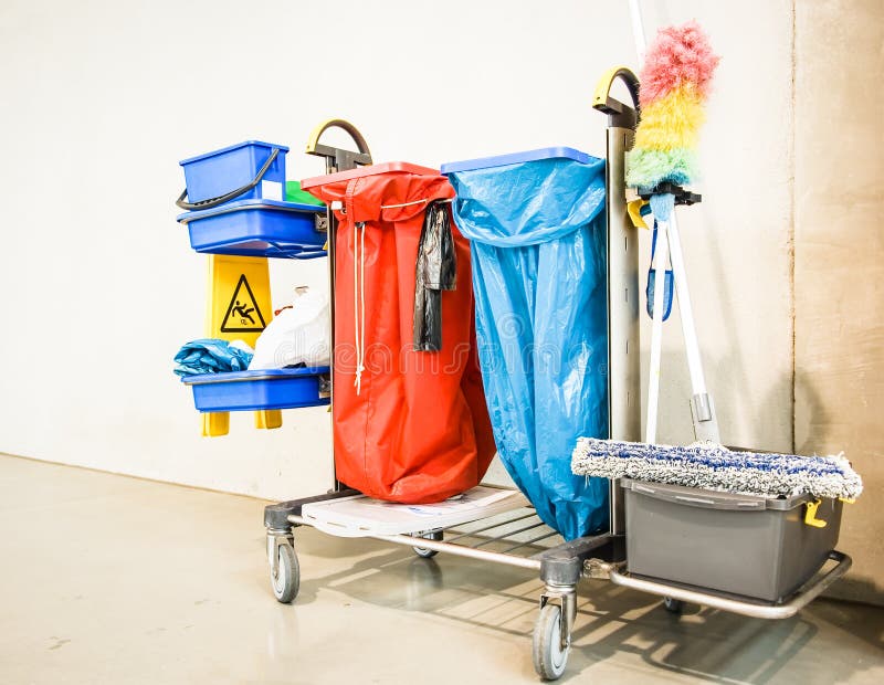 Cleaning Cart in the Station. Cleaning Tools Cart and Yellow Mop Bucket ...
