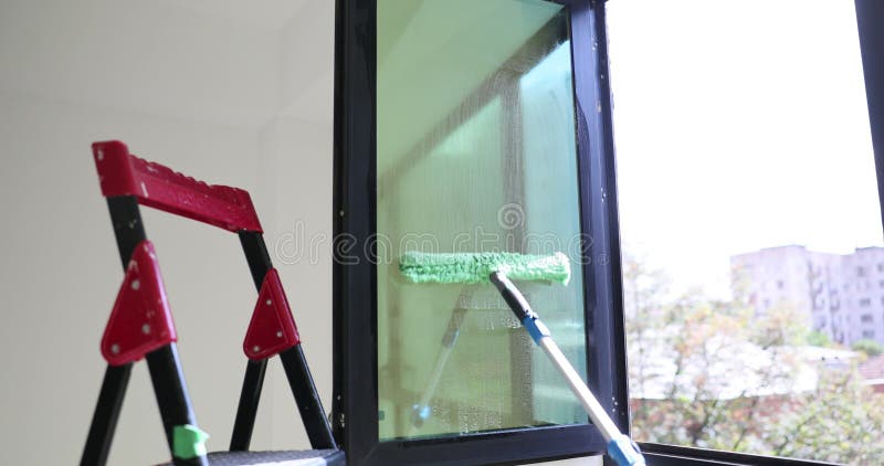Cleaning a Window Using a Scraper and a Ladder Stock Footage - Video of ...