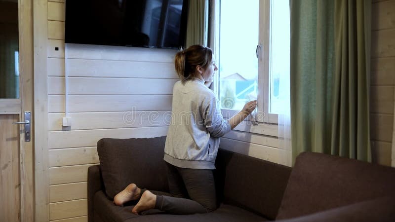 Cleaning Windows in a Cozy Cabin Setting during Daylight Hours in a ...