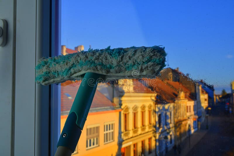 Cleaning Windows with a Squeegee. Cleaning Concept. Washing Window ...