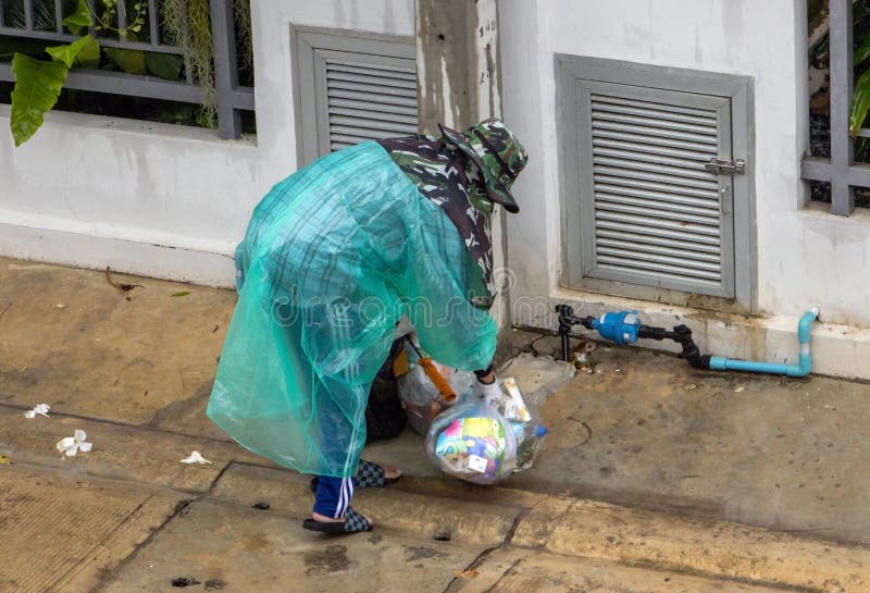A Cleaning Worker Collects Garbage on the Street Stock Photo - Image of ...