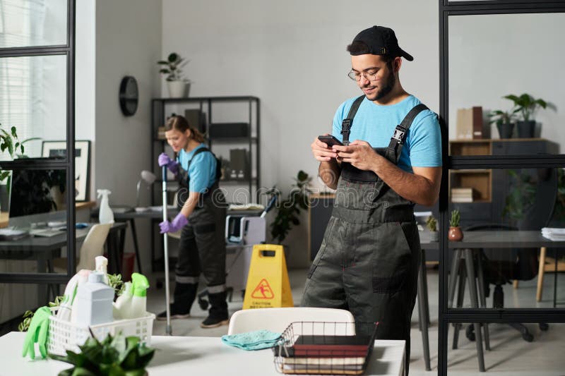 Cleaning Worker Texting Message on Smartphone Stock Image - Image of ...