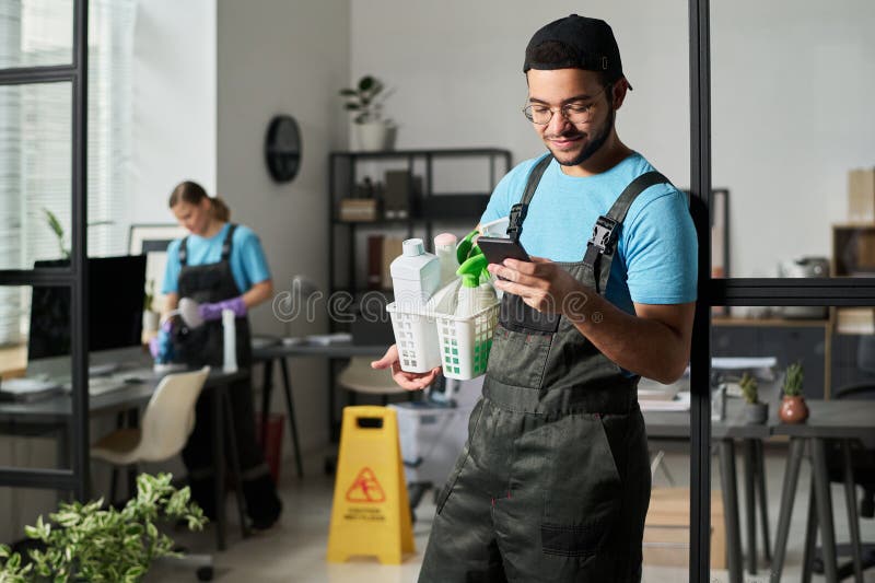 Cleaning Worker Using Smartphone in Office Stock Image - Image of clean ...