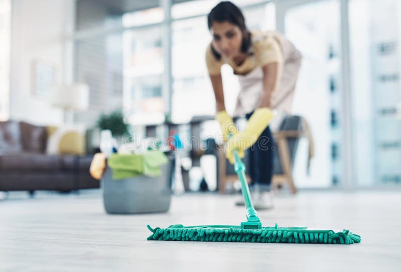 Cleanliness Comes First in Her Home. a Young Woman Mopping the Floor at ...