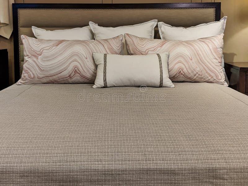 A Cleanly Made Bed, Topped with Several Small Pillows Stock Image ...