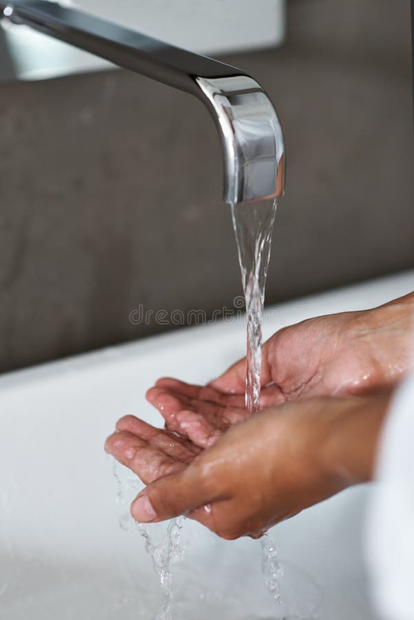 The Cleansing Powers of Water. a Woman Washing Her Hands Under a Tap ...