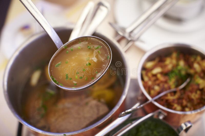 Clear Beef Soup in a Ladle Over a Pot Stock Photo - Image of soup ...
