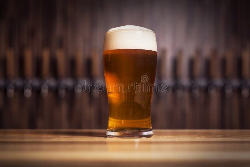 Clear Beer with Foam on the Background of Taps Stock Image - Image of ...