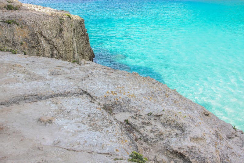 Clear blue sea and rocks stock photo. Image of season - 58832856