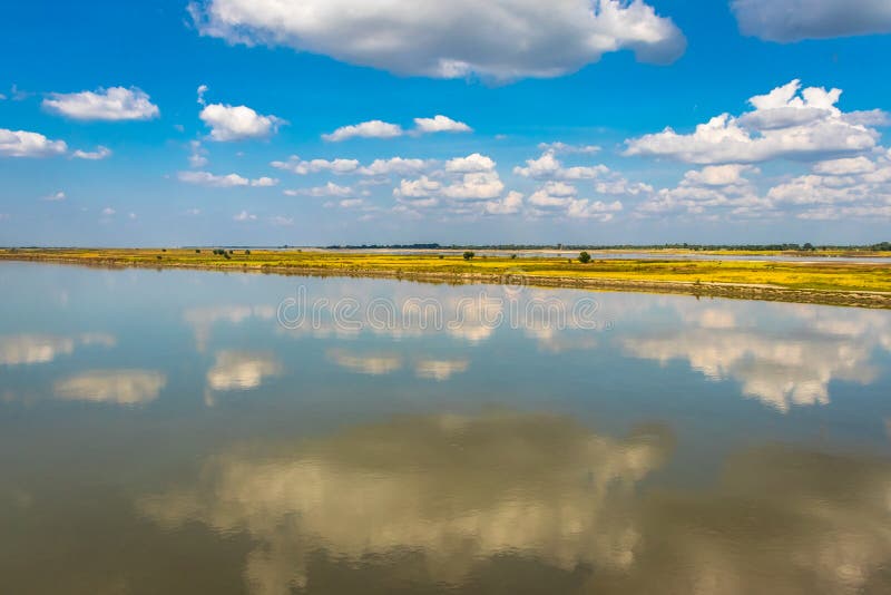 Clear Blue Sky with Many Small Cloud Patch and River Water Reflection ...