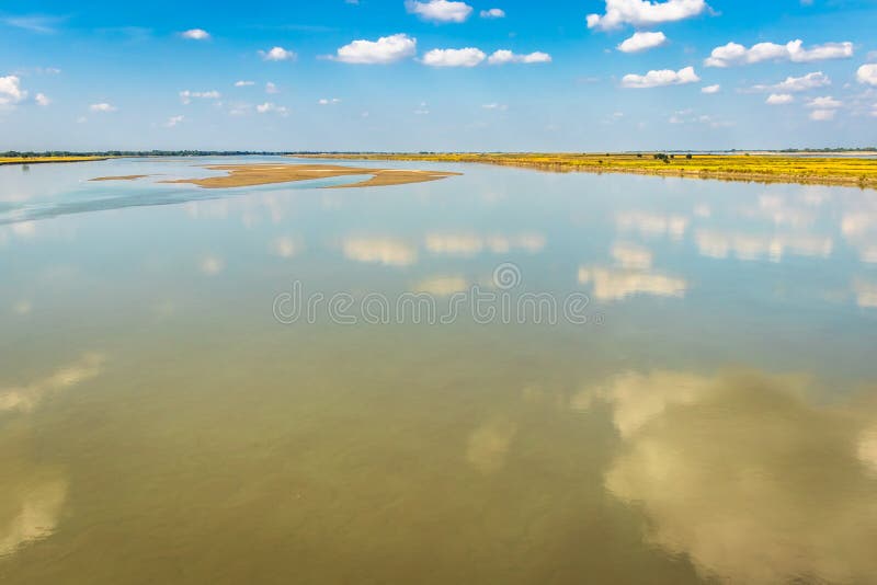Clear Blue Sky with Many Small Cloud Patch and River Water Reflection ...