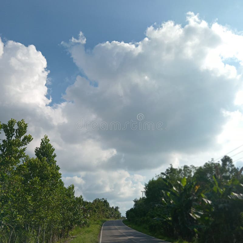 Clear Blue Sky with White Clouds and a Quiet Road Stock Image - Image ...