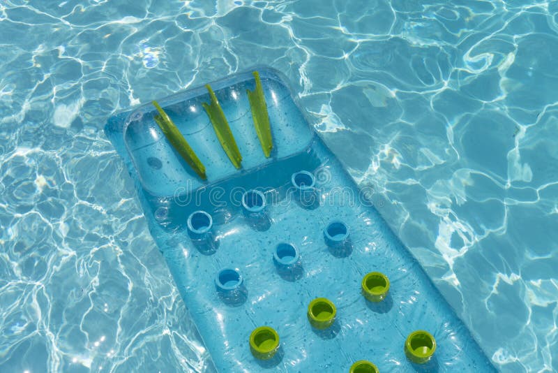 Clear Blue Summer Pool Lounger Float on a Rippled Swimming Pool Stock ...